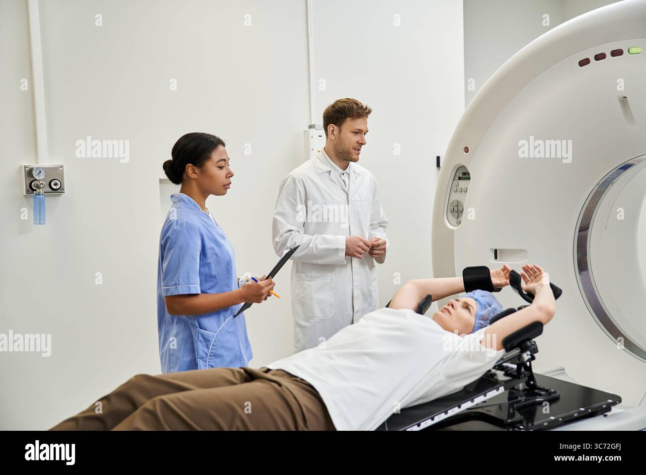 Hands-on healthcare professionals guide a female patient ready for an ...