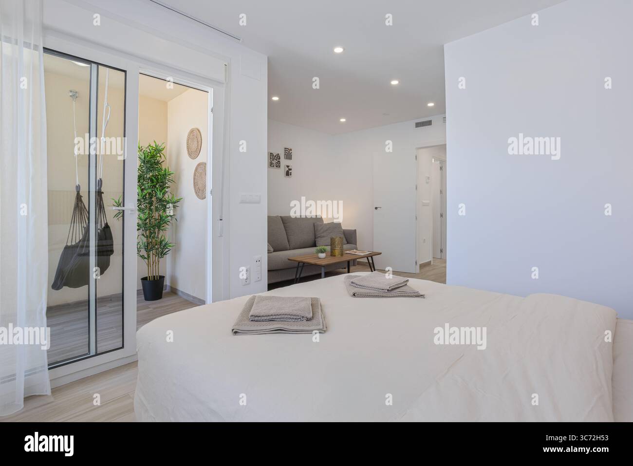 Interior view of a bedroom with soft lighting, neutral tones, and a ...