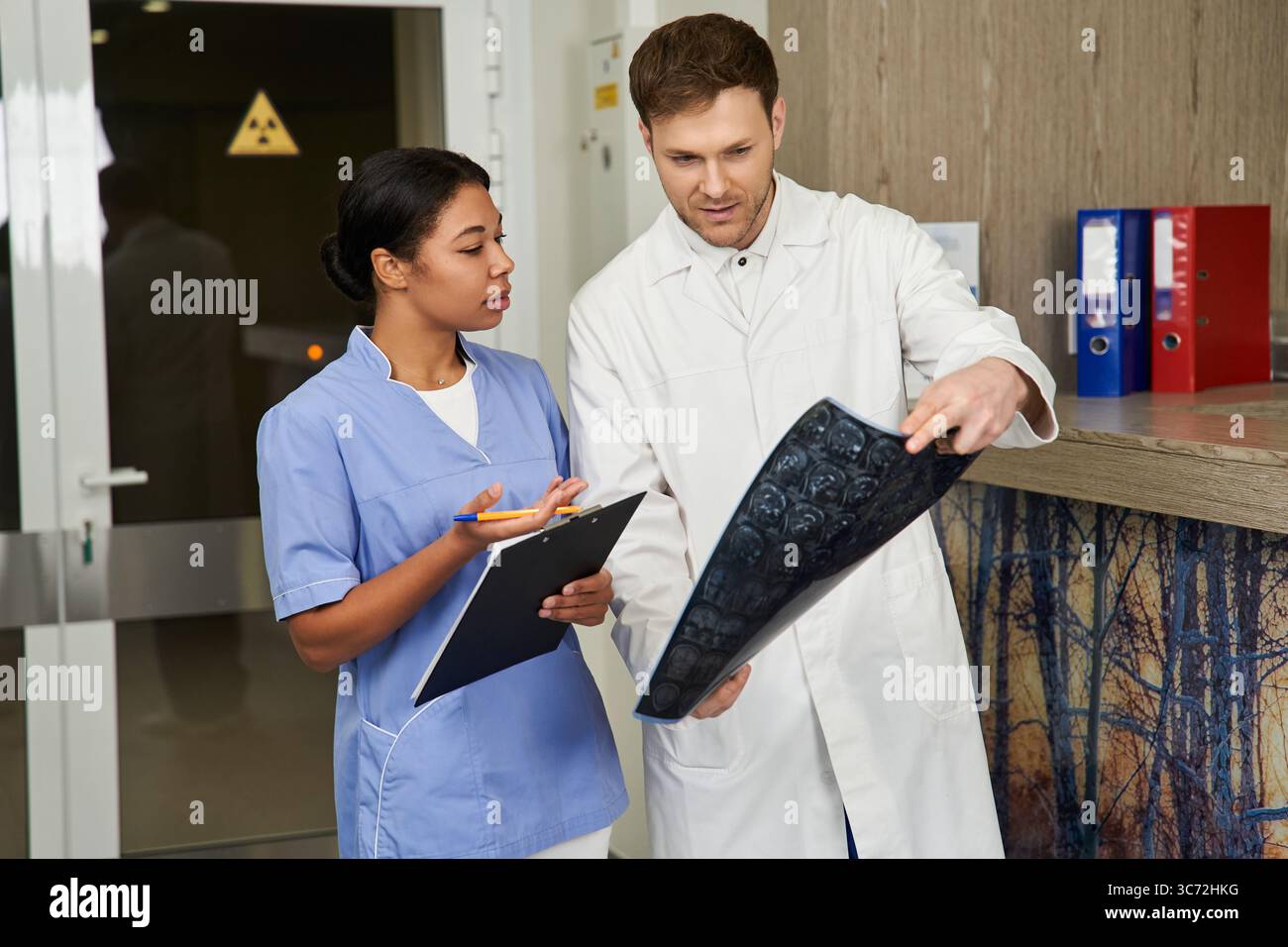Two doctors review MRI scan results in a state-of-the-art hospital ...