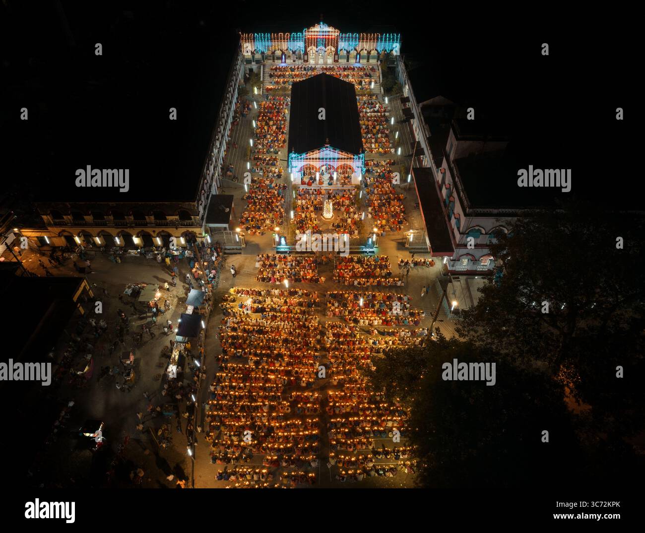 Aerial view of a brightly lit, crowded building during rakher upobash ...