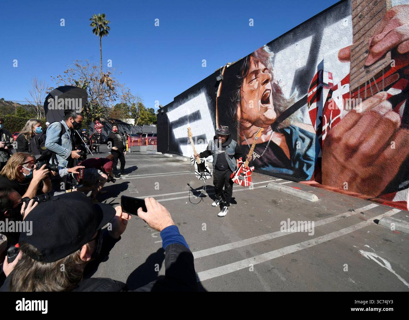 Renowned artist Robert Vargas posses with his Eddie Van Halen mural of ...