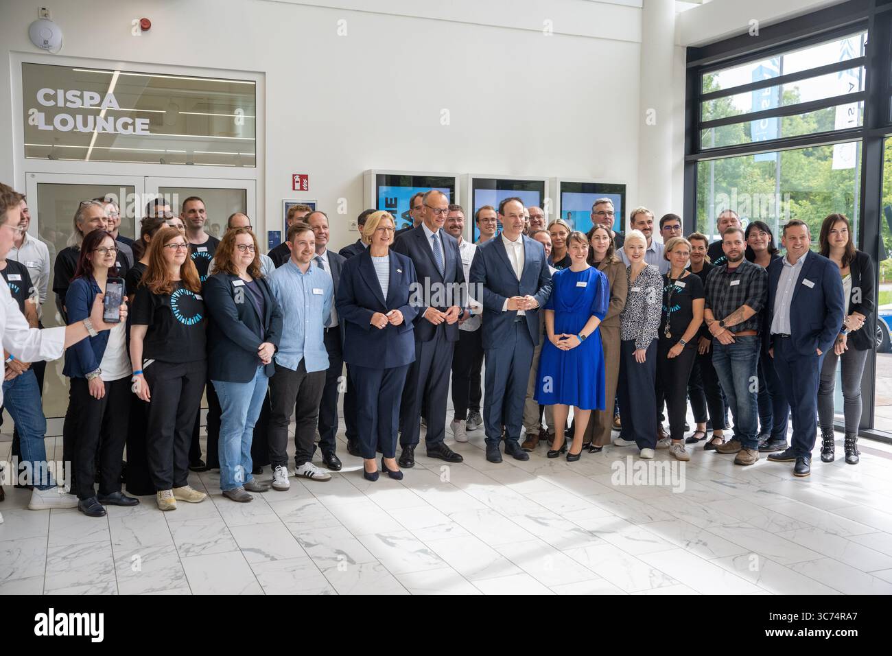 01 August 2025, Saarland, Saarbrücken: Federal Chancellor Friedrich Merz (CDU) poses for a group ...