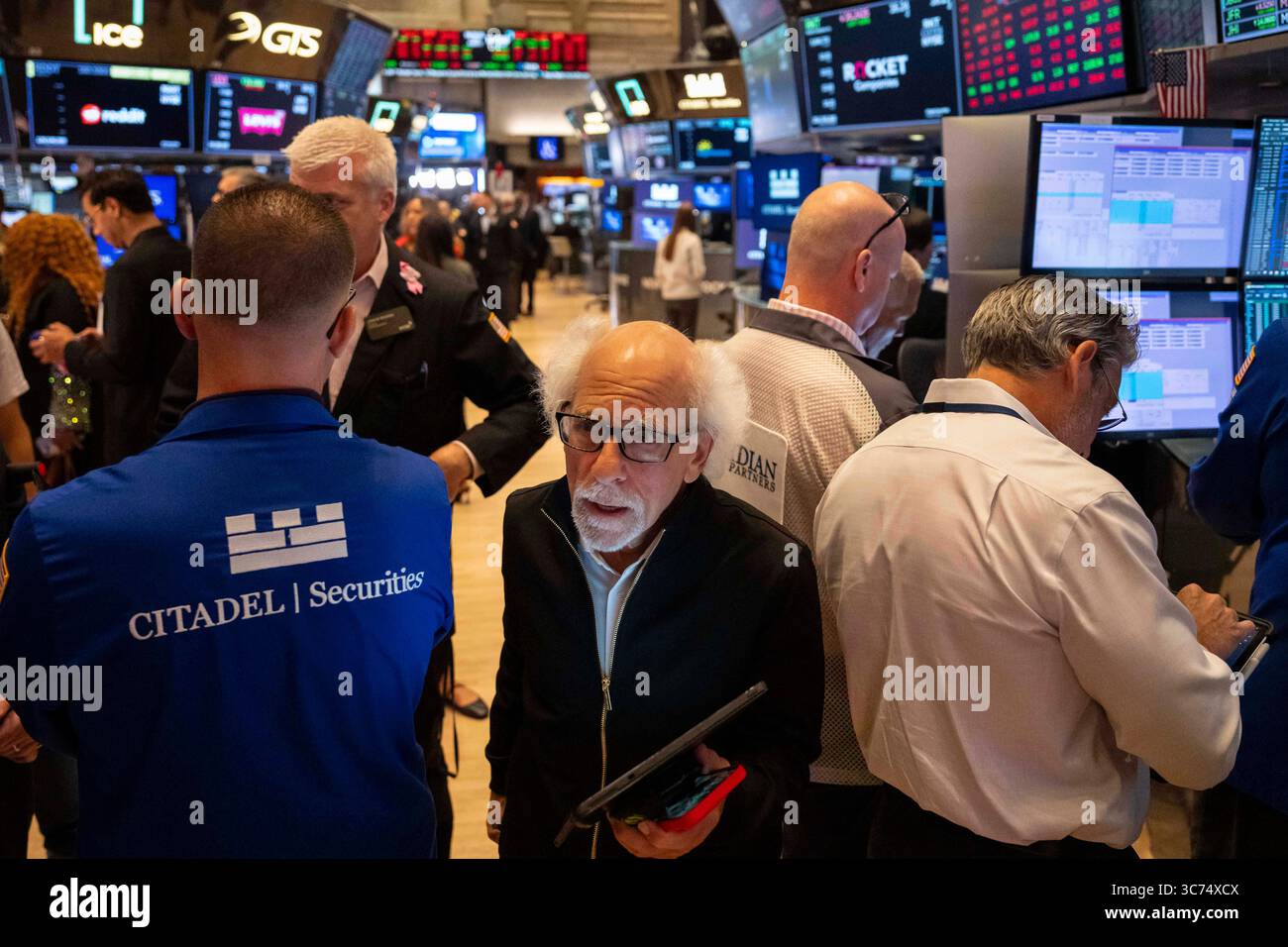 Trader Peter Tuchman works on the floor of the New York Stock Exchange ...