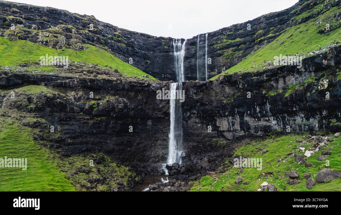 Water tumbles gracefully from towering cliffs in the stunning ...