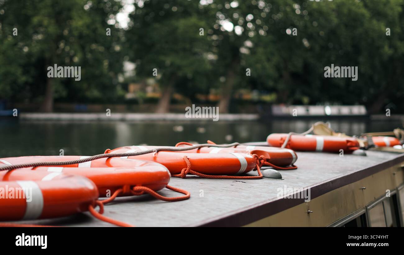 Lifebuoys secured on roof of small boat used for safety during marine ...