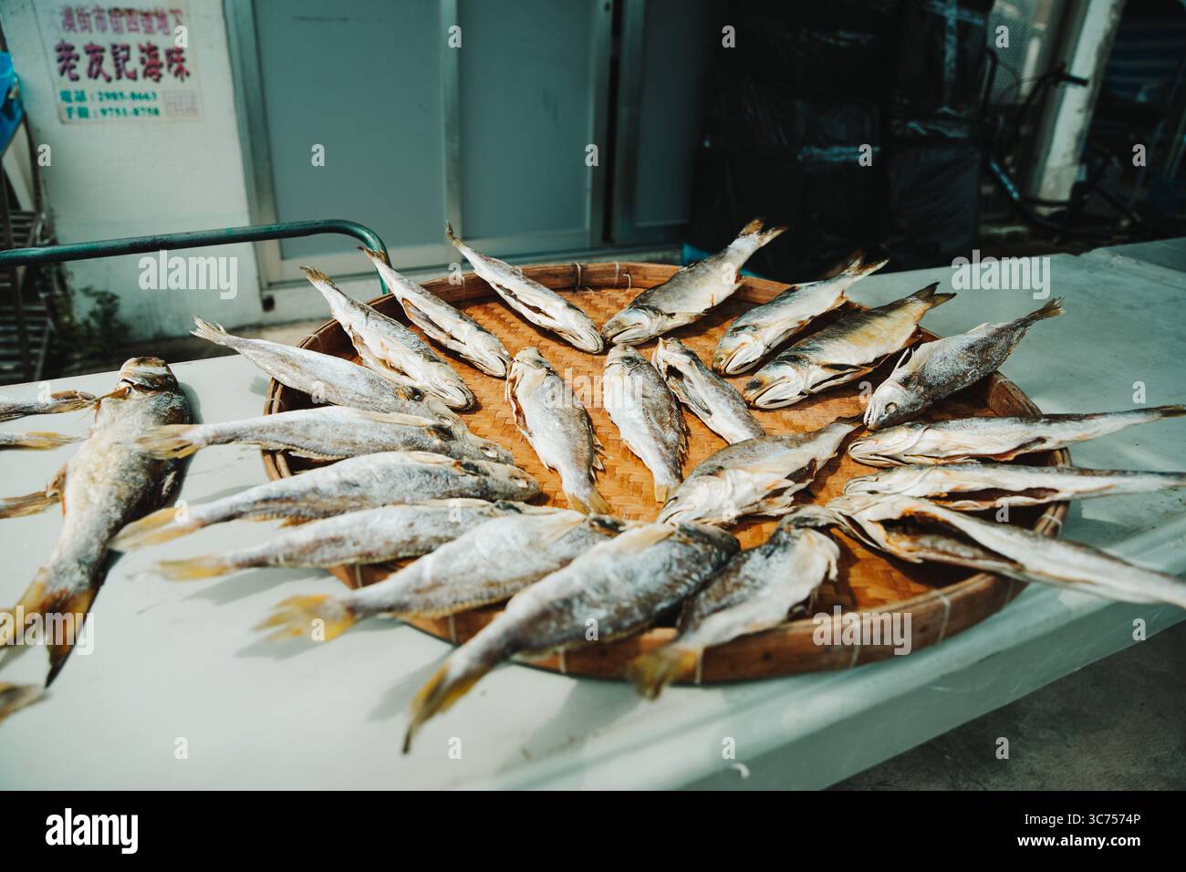 Preserved salted fish hanging on display at a traditional street market ...