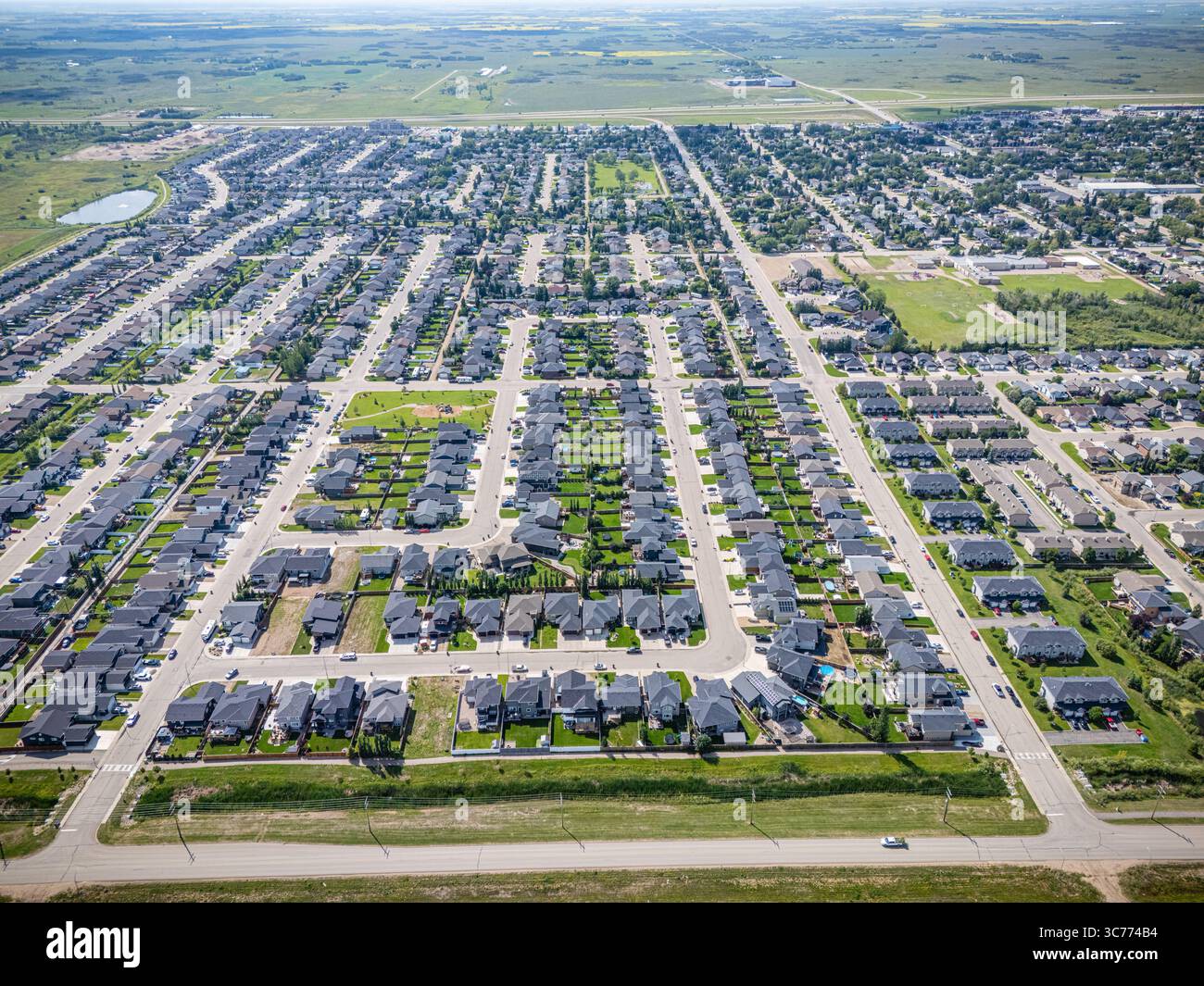 Residential area with many houses and a few cars. The houses are mostly ...