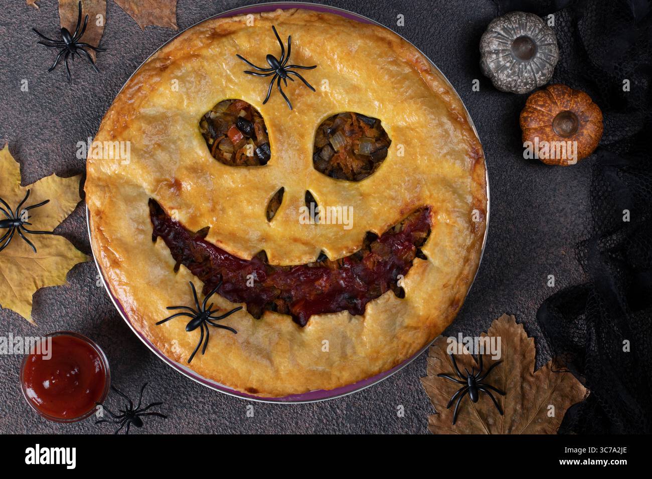 Halloween homemade vegetables pie with scary face. Autumn theme Top ...