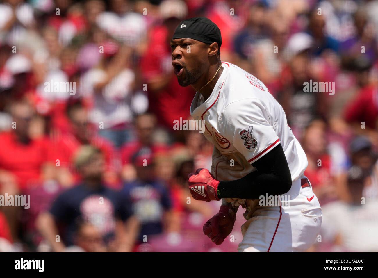 Cincinnati Reds' Will Benson reacts after scoring on a single hit by ...