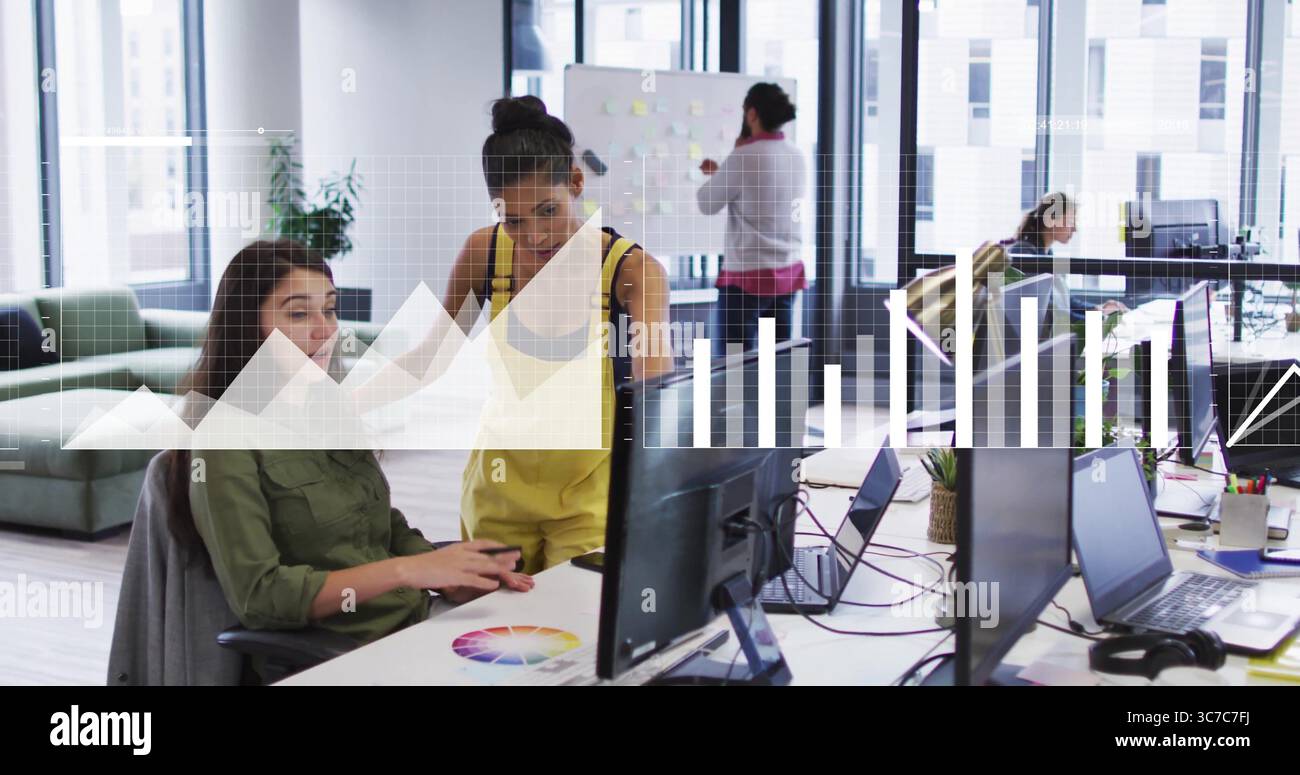 Collaborating two coworkers typing and pointing at screen in shared ...