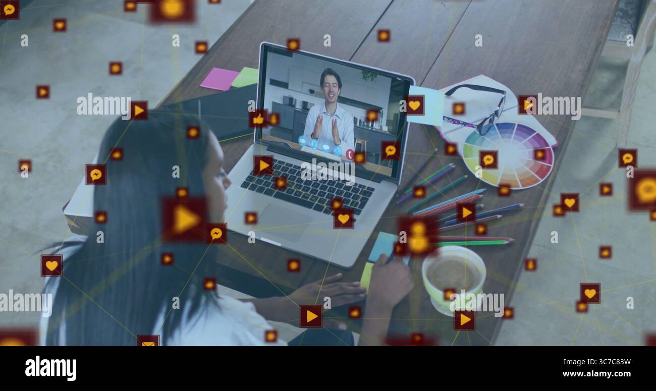 African American woman taking notes during virtual call in home office ...