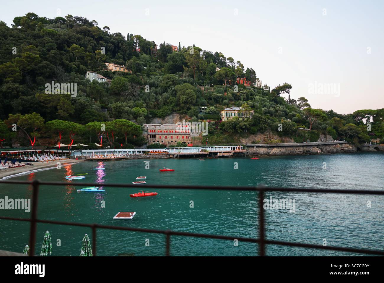Luxury beach resort on the Italian Riviera at sunset. Colorful boats ...