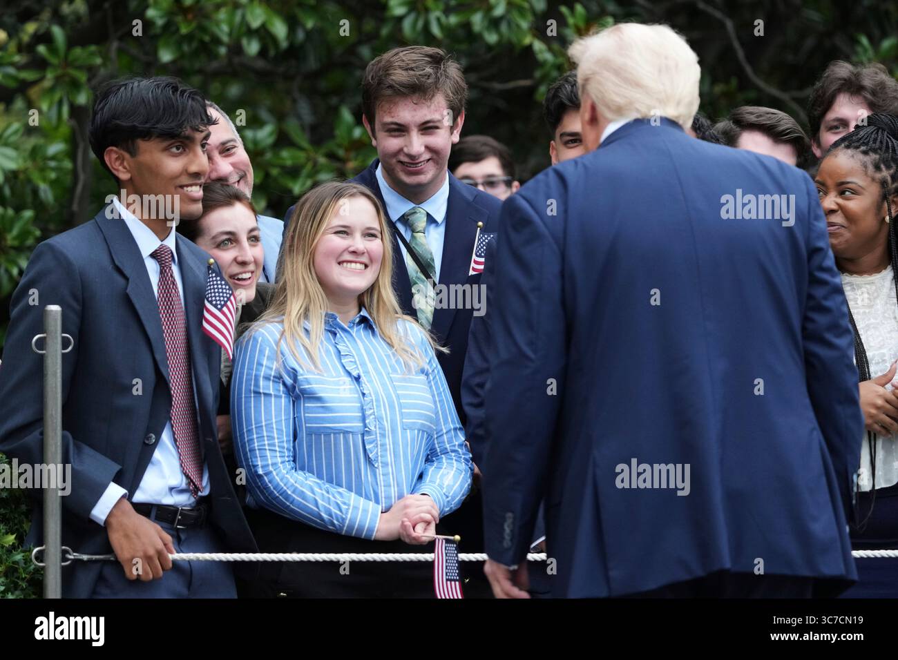 President Donald Trump greets interns before walking across the South ...