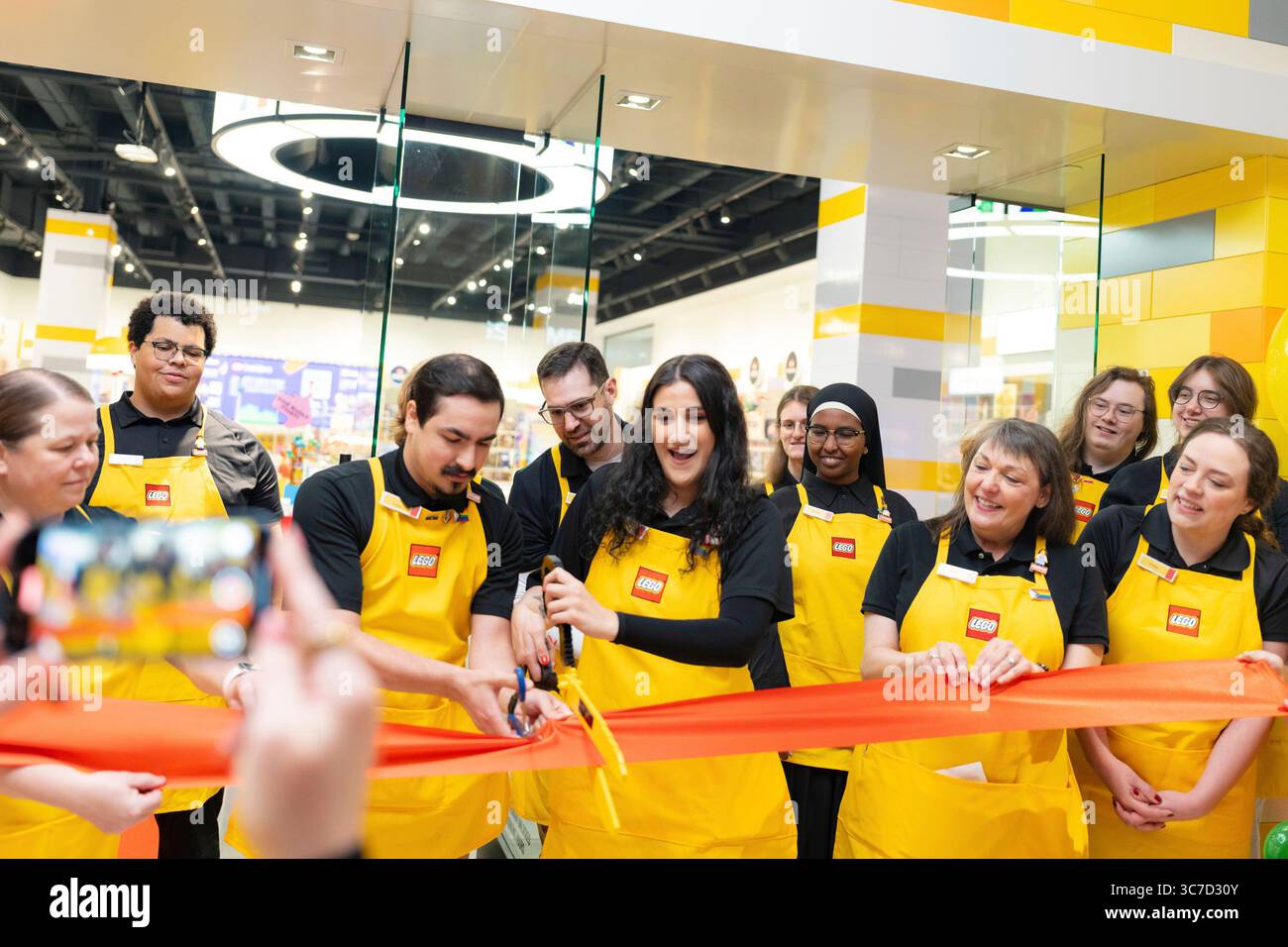 IMAGE DISTRIBUTED FOR THE LEGO GROUP - LEGO employees cut the ribbon at ...