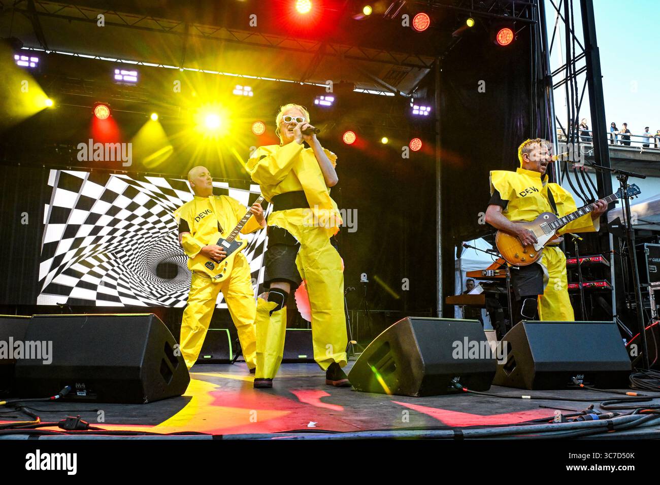 L-R: Josh Hager, Mark Mothersbaugh, Bob Mothersbaugh of Devo performing ...