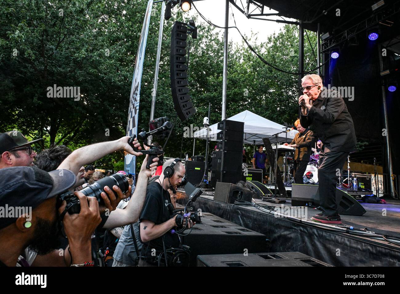 View of photographers in the photo pit as Mark Mothersbaugh of Devo ...