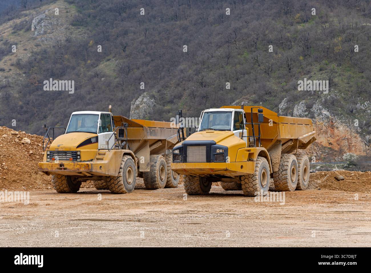 Two Articulated Hauler Dump Trucks at Public Road Construction Site ...