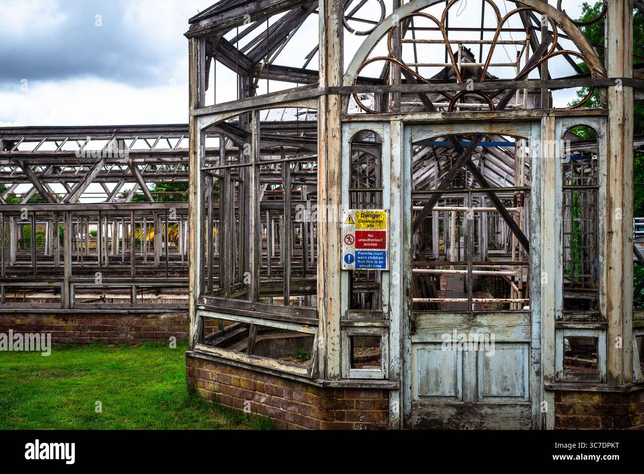 Dilapidated greenhouse showing a danger warning sign (at Luton Hoo ...