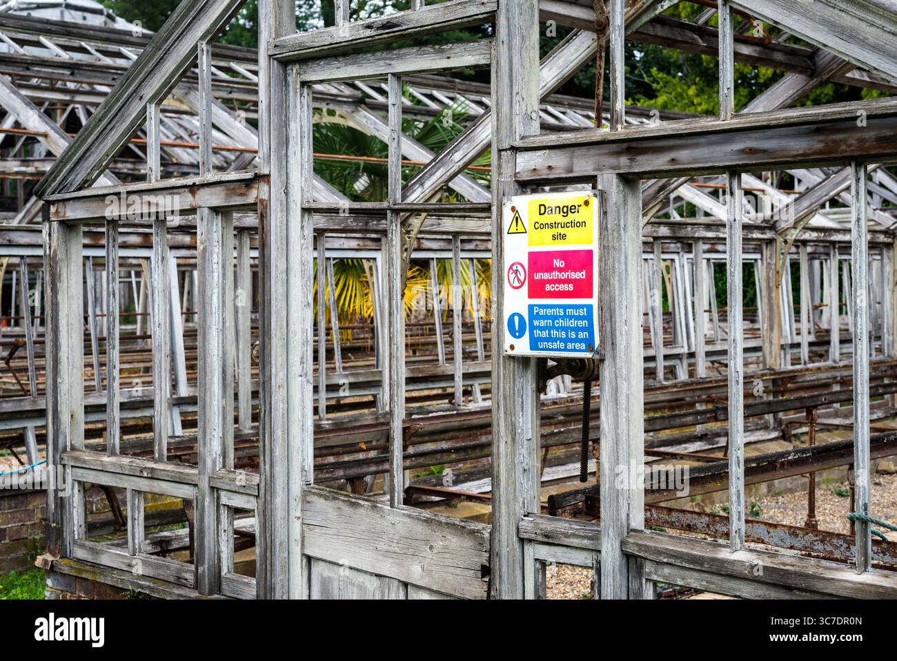 Dilapidated greenhouse showing a danger warning sign at (Luton Hoo ...