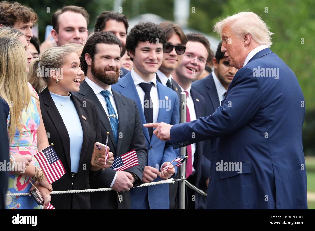 President Donald Trump greets interns before walking across the South ...