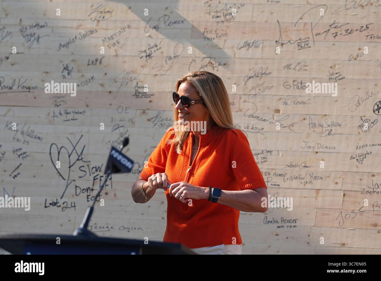 Denver Broncos co-owner Carrie Walton Penner caps a marker after ...
