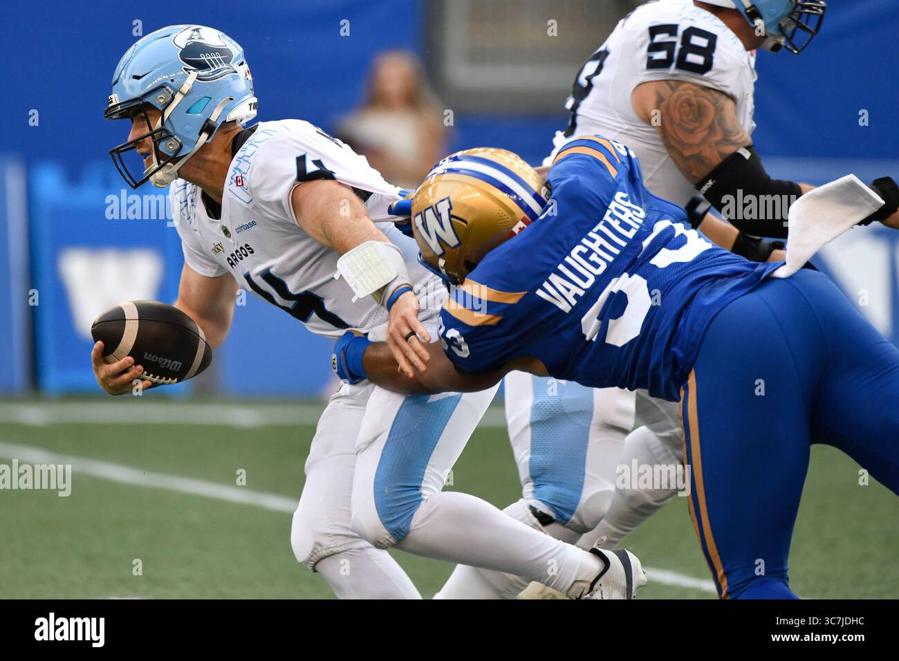 Toronto Argonauts' quarterback Nick Arbuckle (4) is sacked by Winnipeg ...