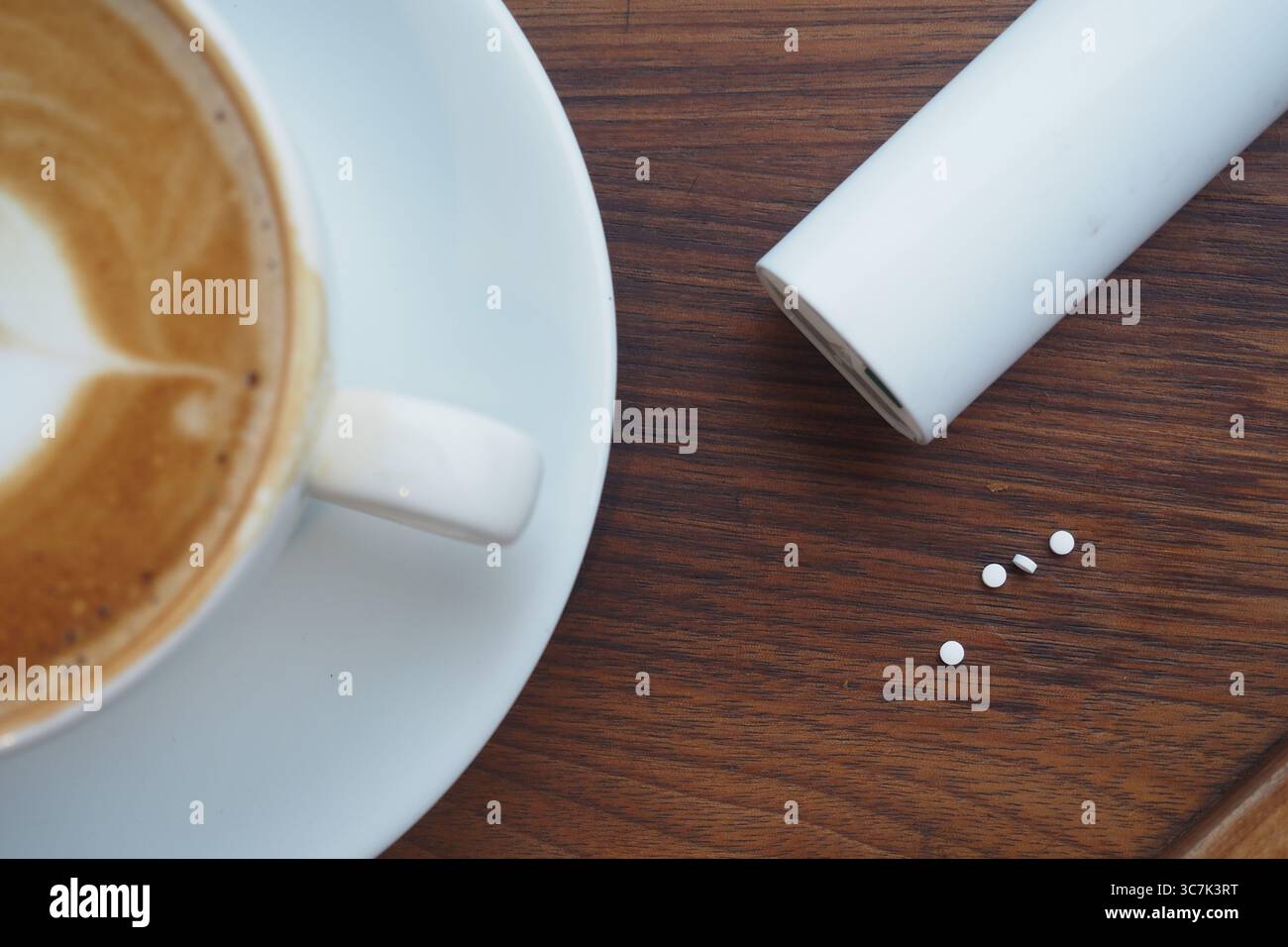 Coffee cup and sweetener sugar substitute on a tablel Stock Photo - Alamy