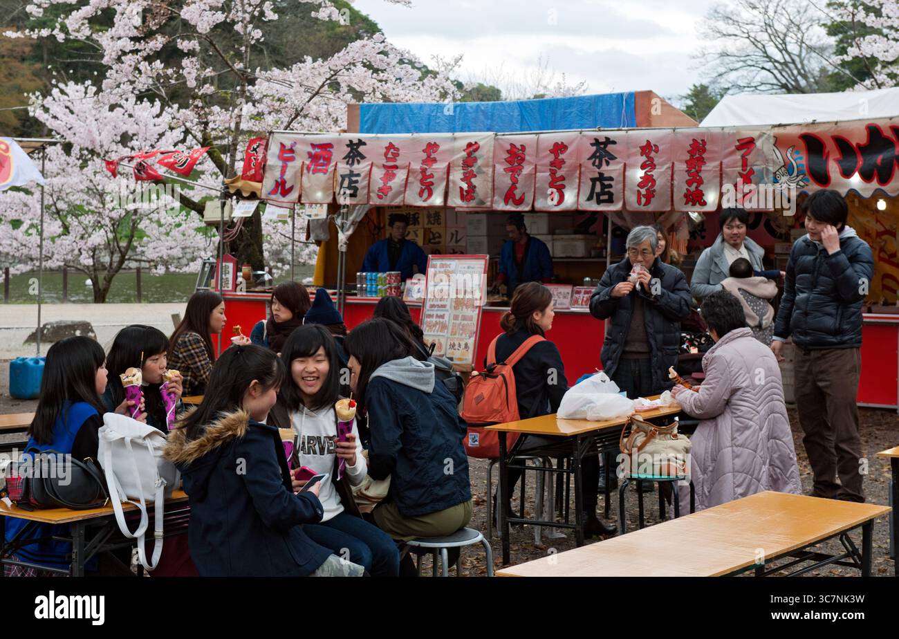 Japanese people enjoying a "hanami" lunch break at an outdoor food ...