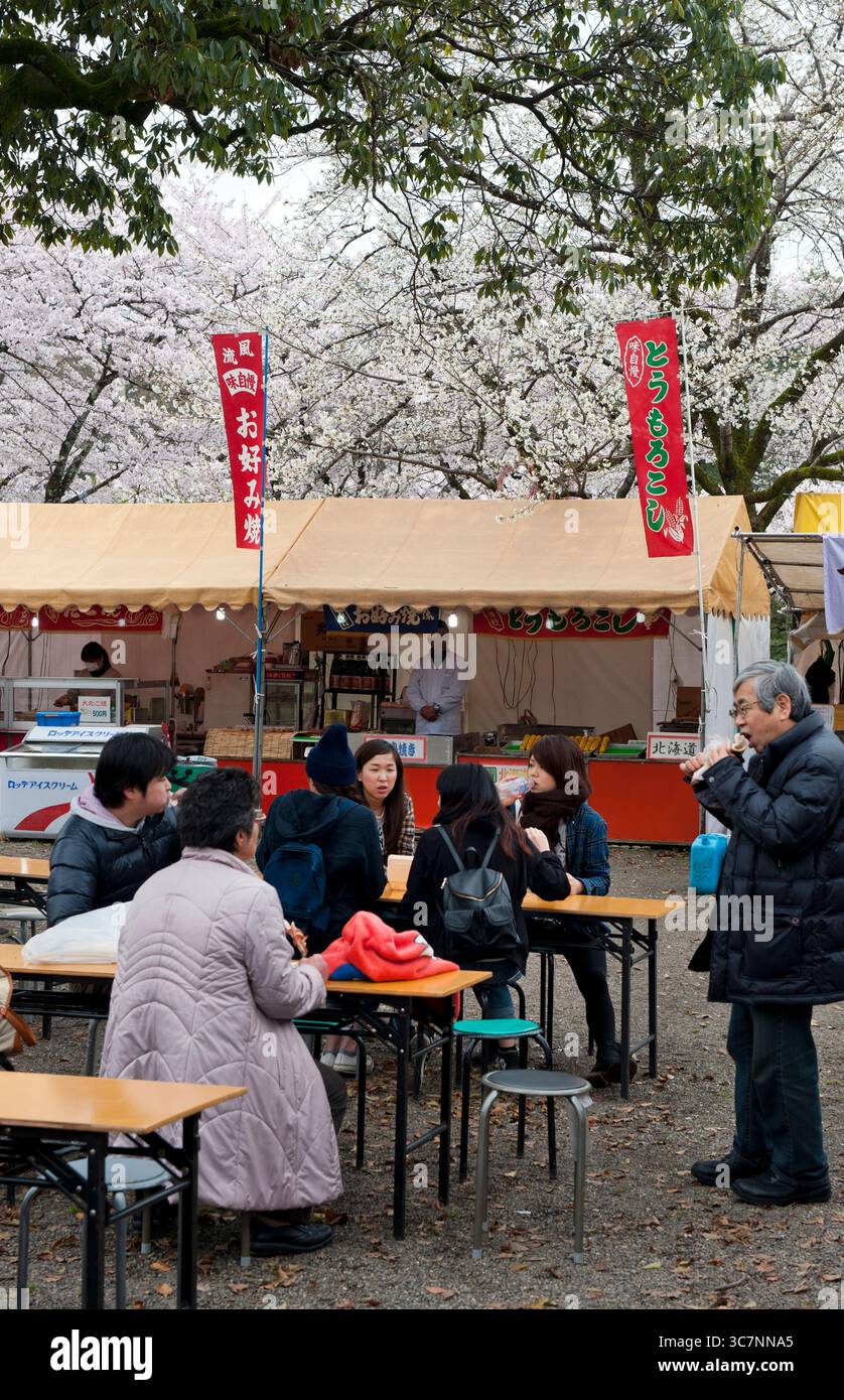 Japanese people enjoying a "hanami" lunch break at an outdoor food ...