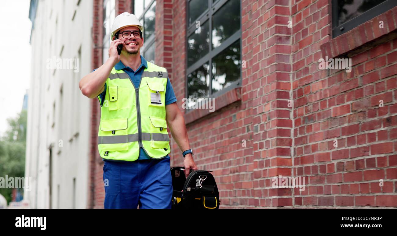 Hispanic Factory Worker Making Business Call At Construction Site Stock ...