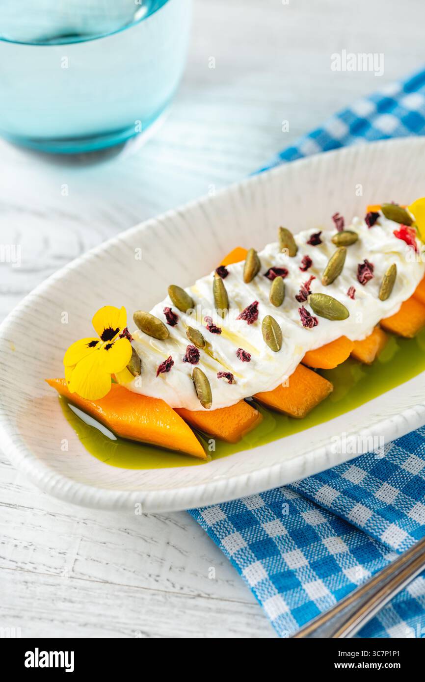 Zucchini and yogurt appetizer with capers and edible flowers Stock ...