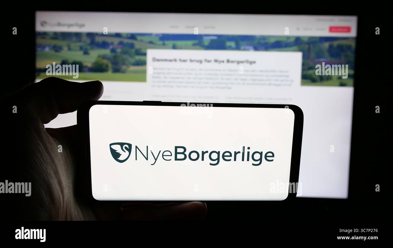 Stuttgart, Germany - 07-11-2025: Person holding cellphone with logo of Danish political party ...