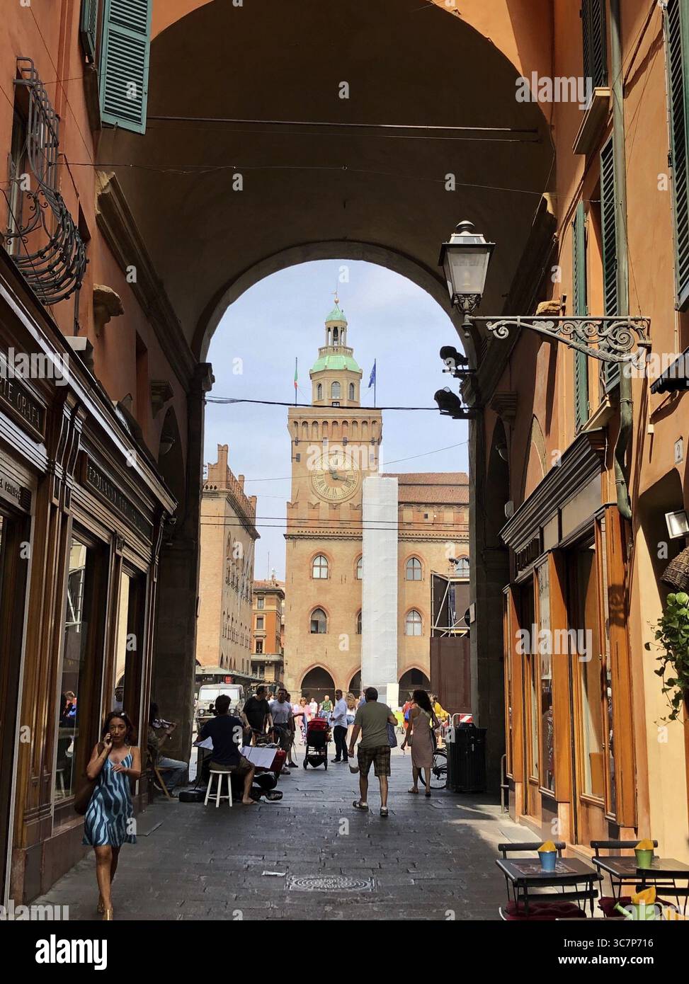 View through arcade to the historic clock tower in Bologna, animated by ...