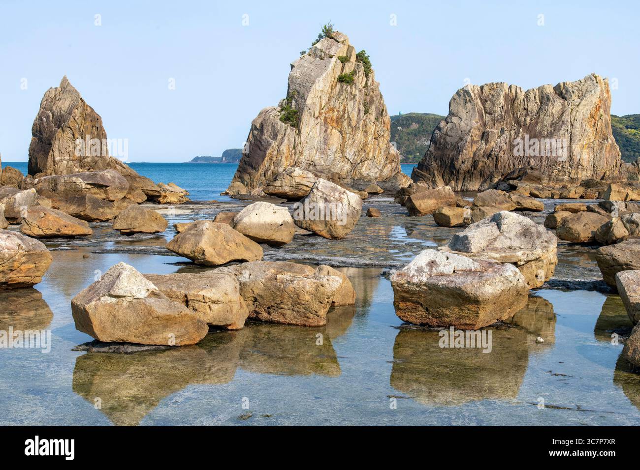 Close up and reflection in water of Hashiguiiwa, a coastal rock ...