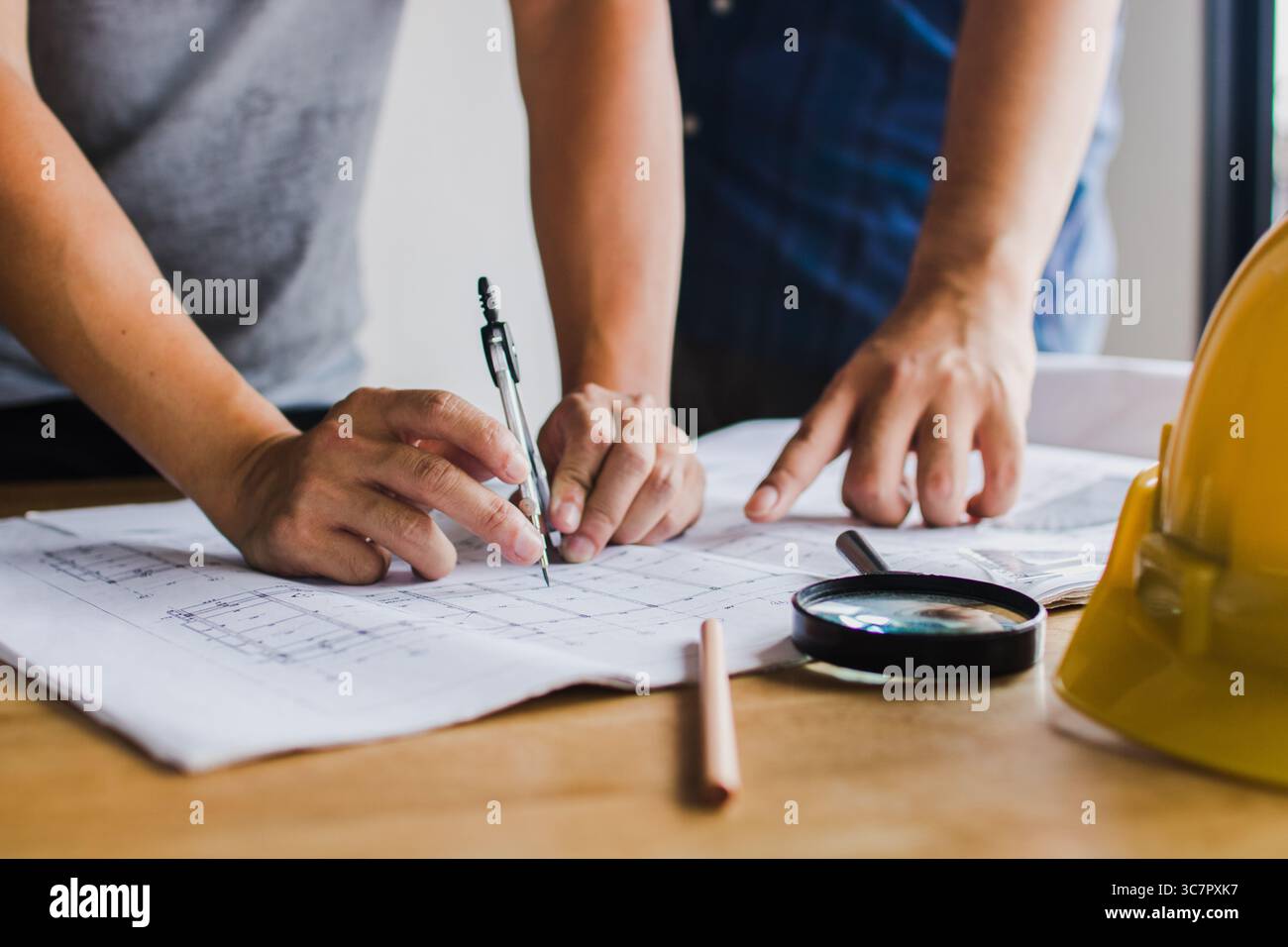 Close up hand of architect is designing using a blueprint for ...