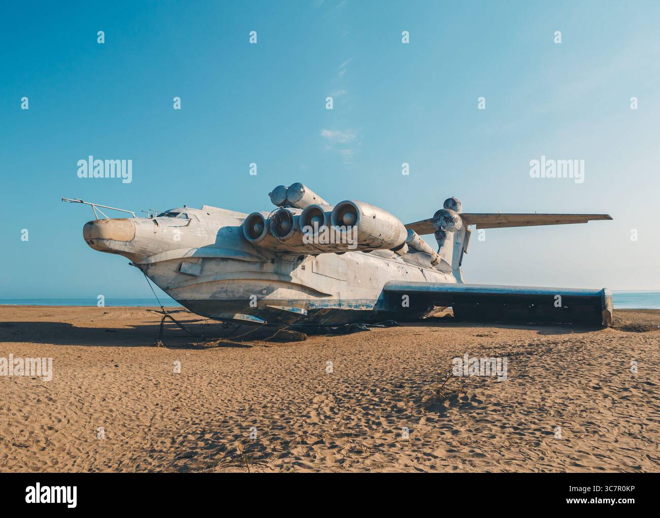 Forgotten Lun-class ekranoplan rests on a sandy beach along the Caspian ...