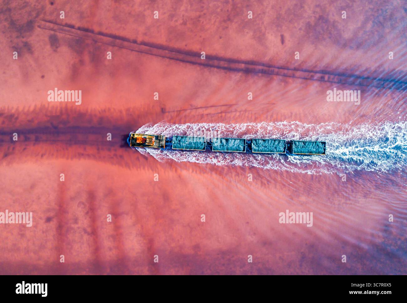 Aerial view of an old train rides on the railway laid in the water ...