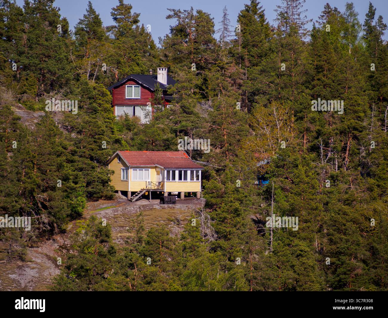 Traditional Swedish holiday cabins in the Stockholm Archipelago seen ...