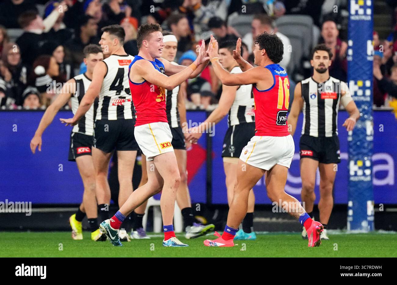 Logan Morris of the Lions celebrates after kicking a goal during the ...
