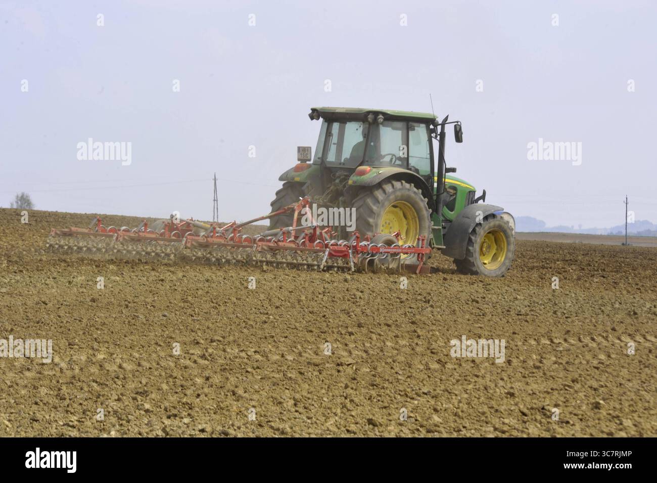 Soil cultivation and farming with a tractor in the field Soil ...