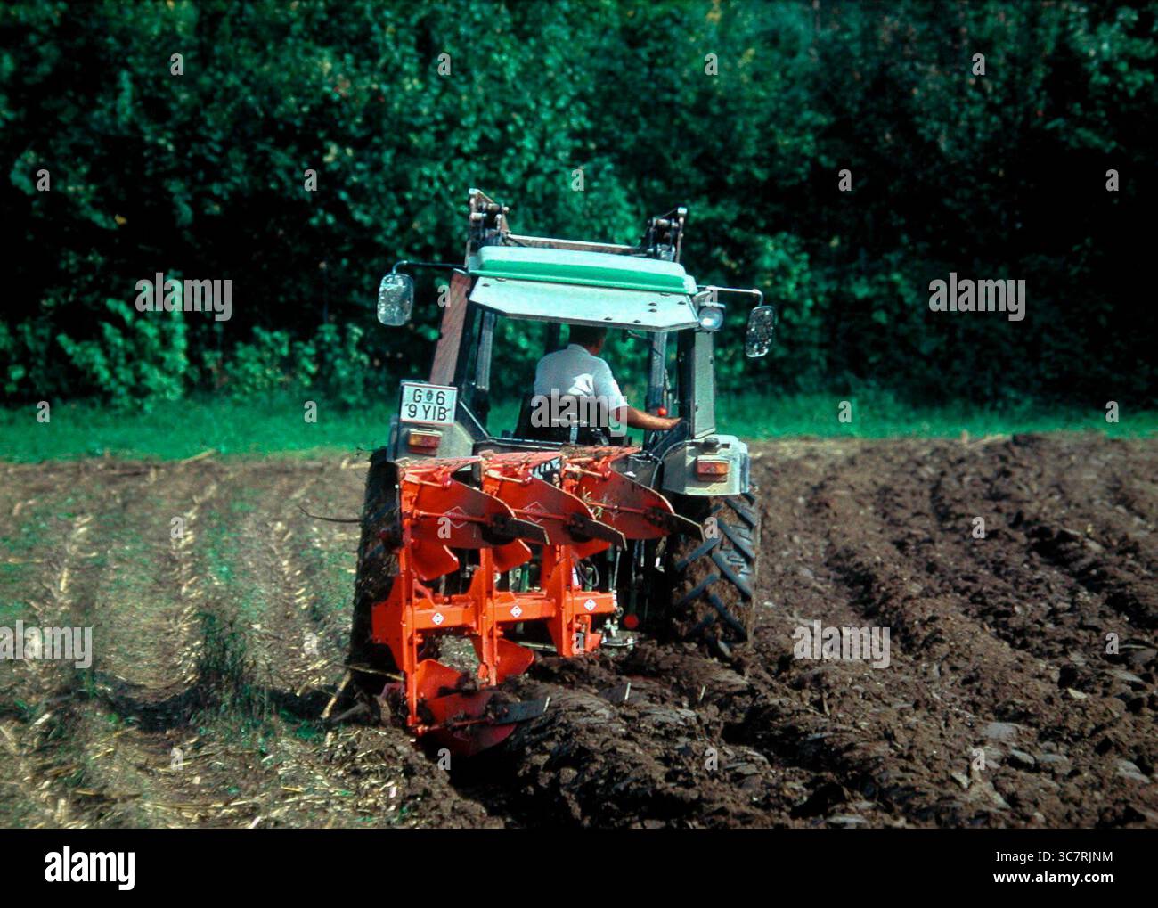 Soil cultivation and farming with a tractor in the field Soil ...