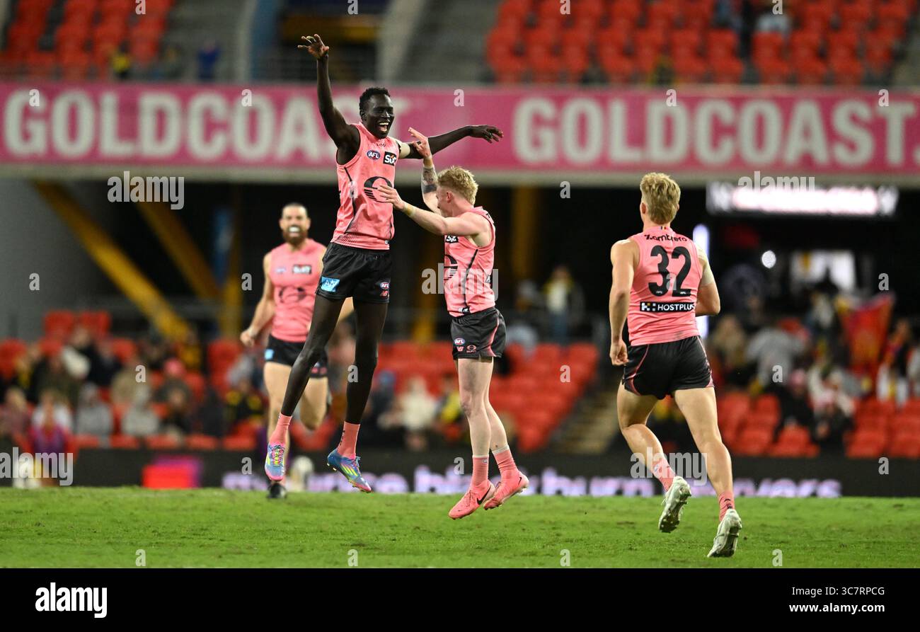 Mac Andrew (left) of the Suns celebrates kicking a goal with team mates ...
