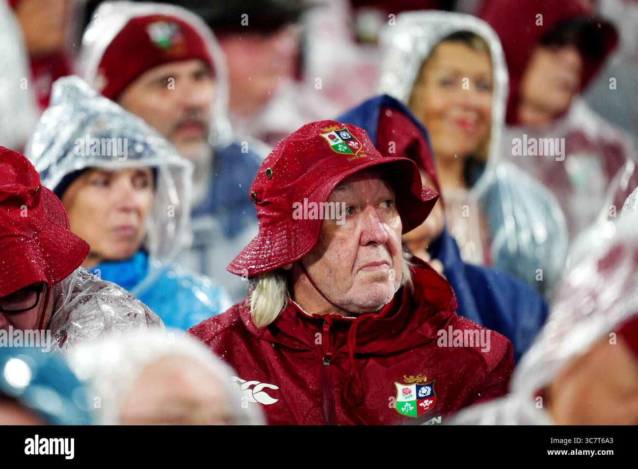 British and Irish Lions supporters watch on as rain falls during the ...
