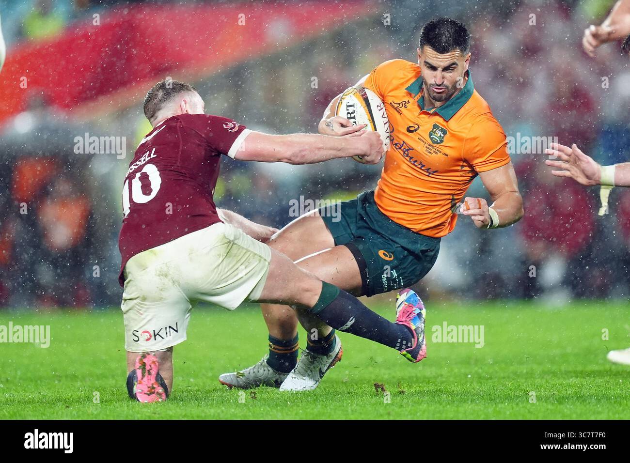 Australia's Tom Wright (right) is tackled by British and Irish Lions ...