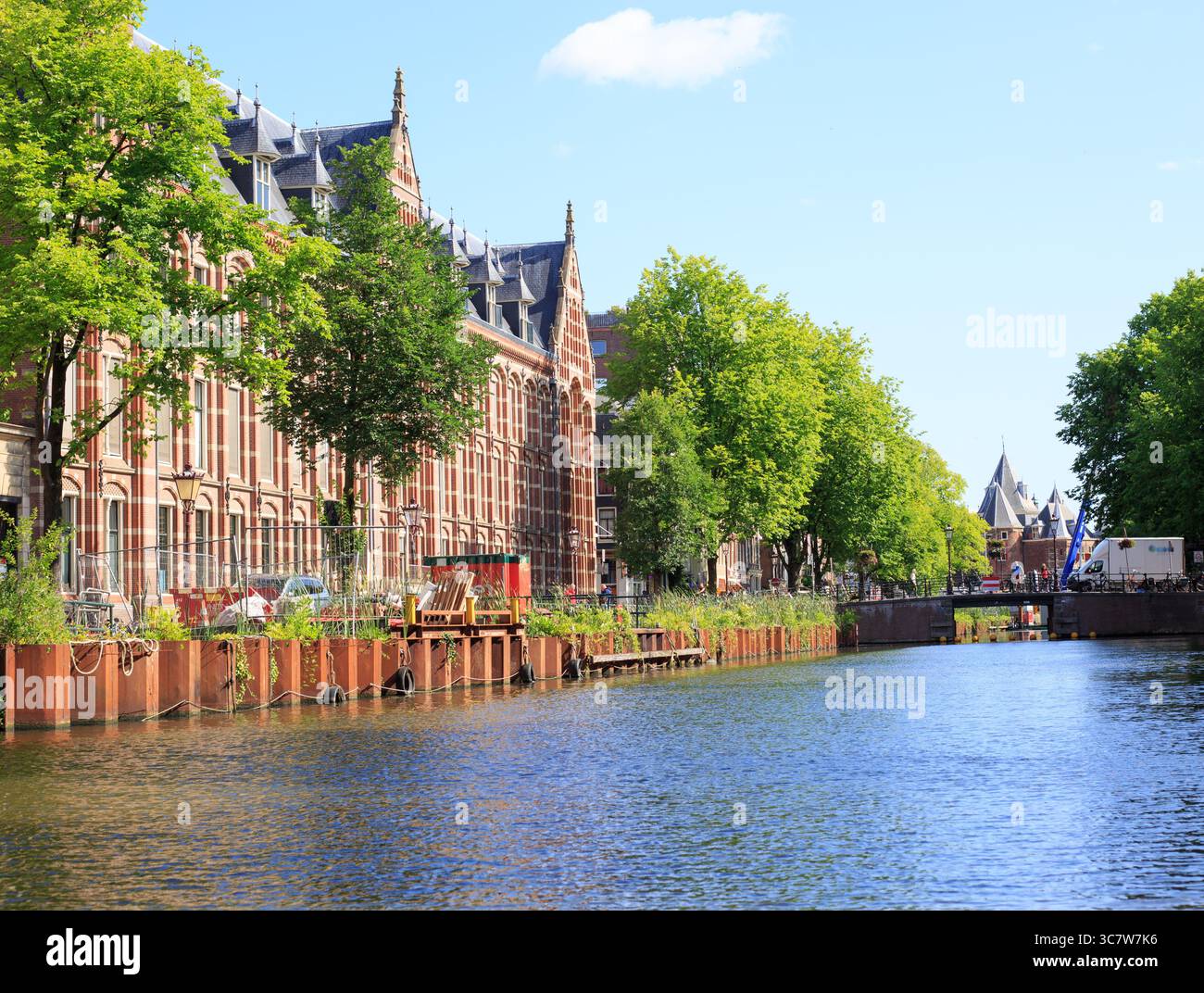 Pretty view along a canal in Amsterdam, netherlands with red-brick ...