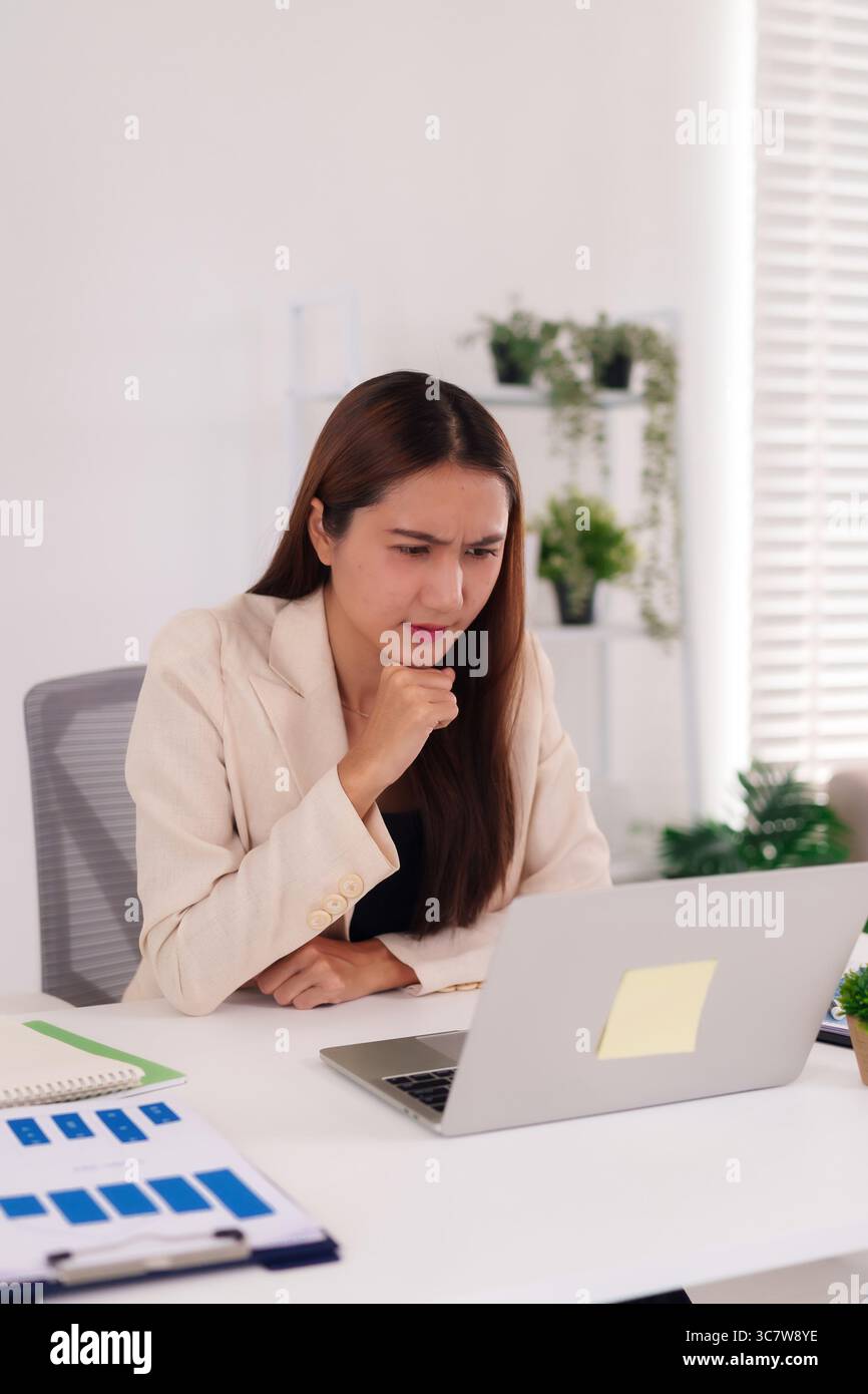 Asian professional woman focused deeply analyzing business data on ...