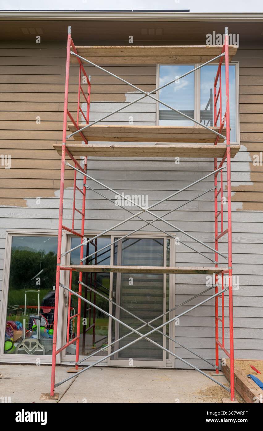 Construction scaffolding set up outside a home for repair work on the ...