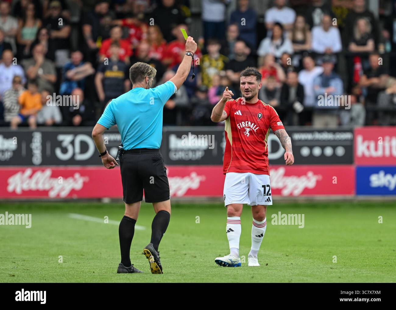 Salford City's Tom Edwards receives a yellow card from referee Neil ...