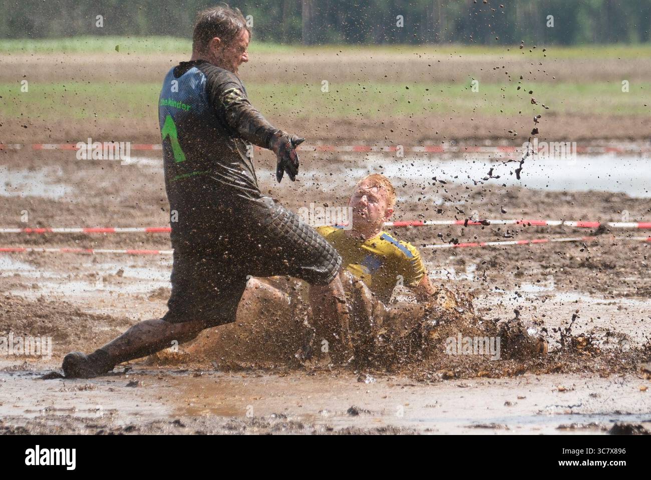 02 August 2025, Saxony, Wöllnau: Participants in the German Mud ...