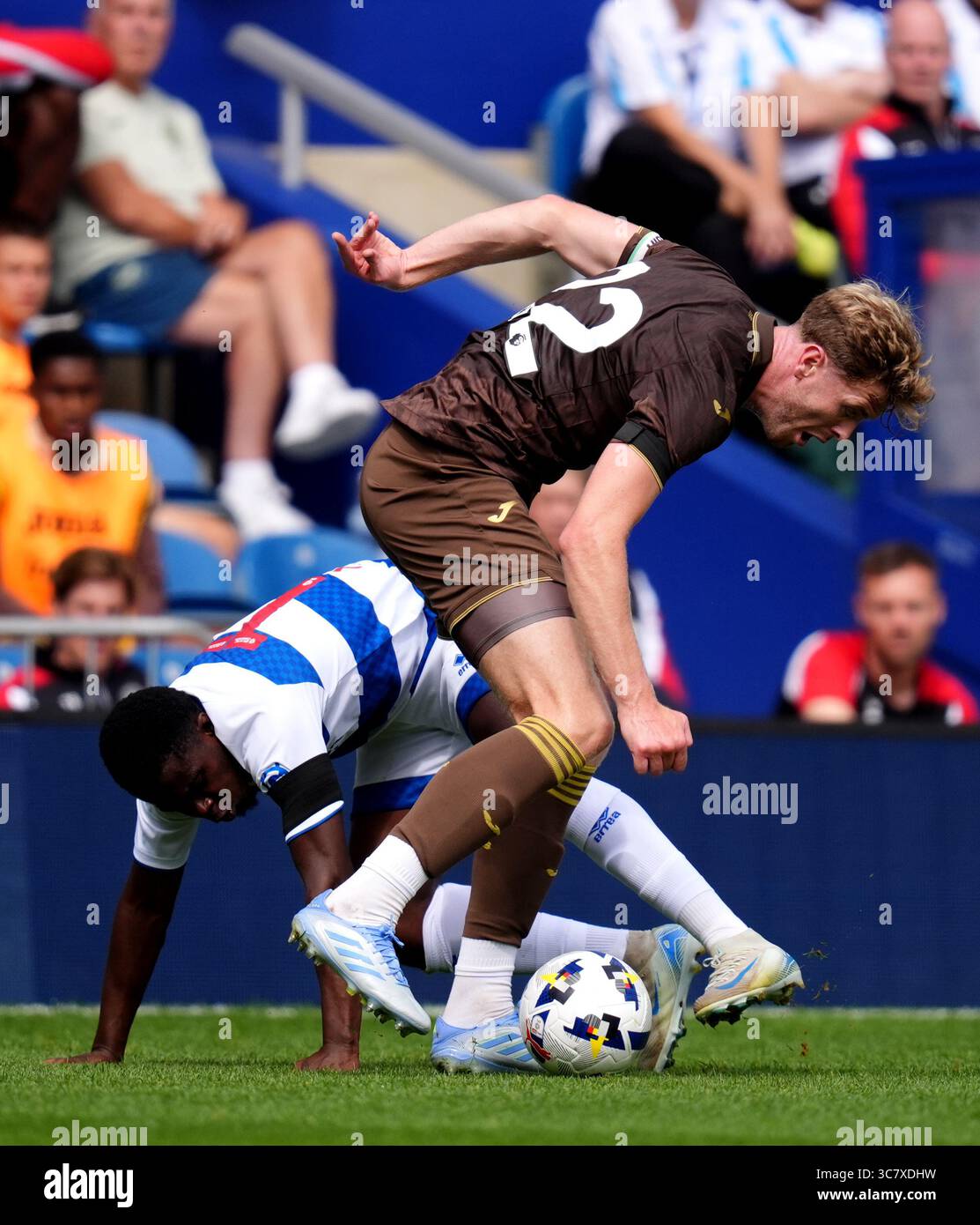 Brentford's Nathan Collins (right) battle for the ball with Queens Park ...